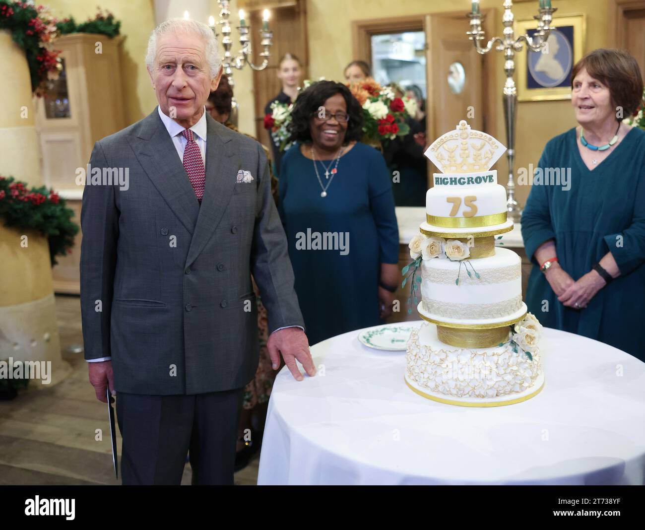 King Charles III next to a birthday cake during his 75th birthday party ...