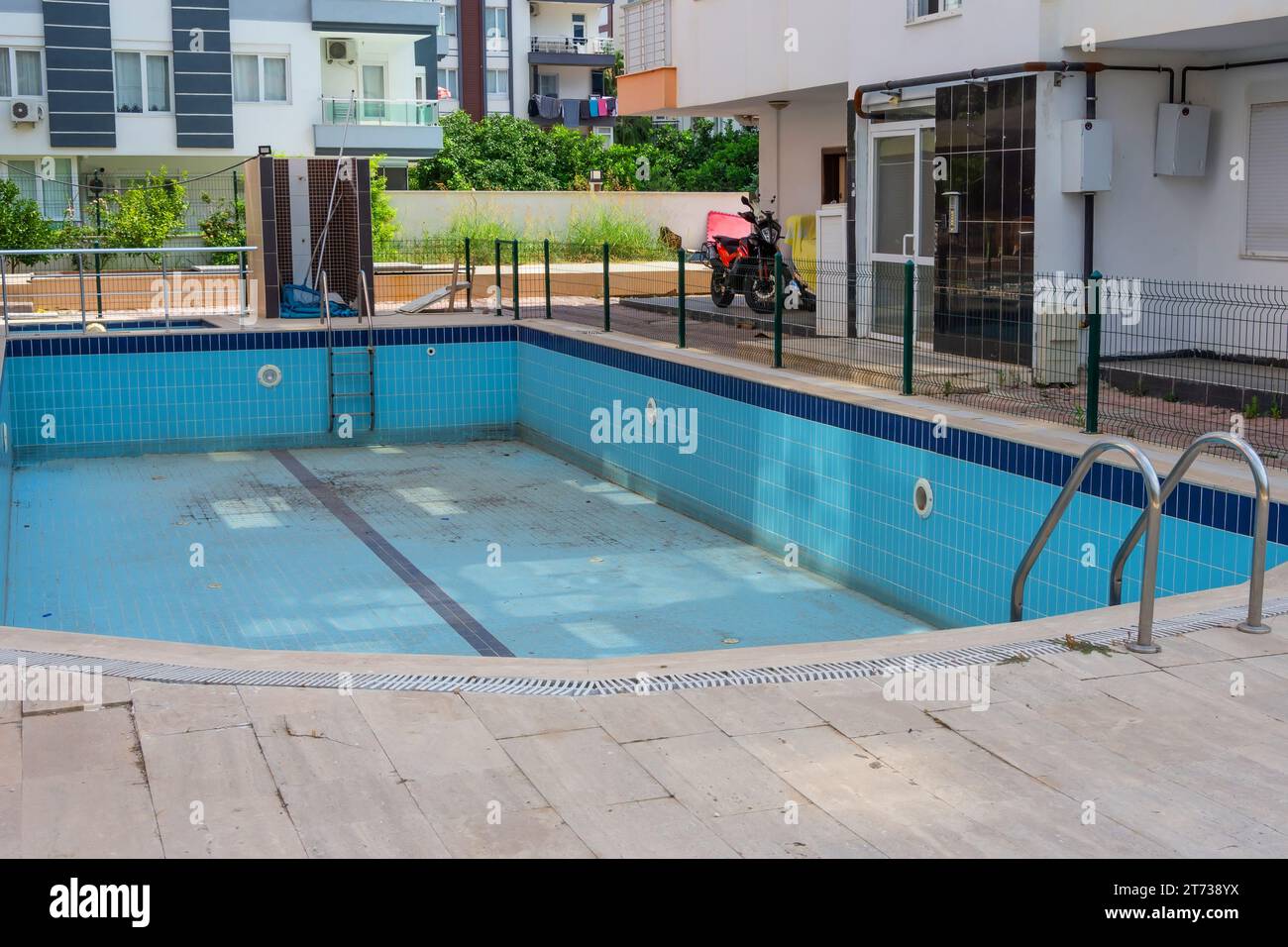 Empty swimming pool in the courtyard of a residential building, city ...