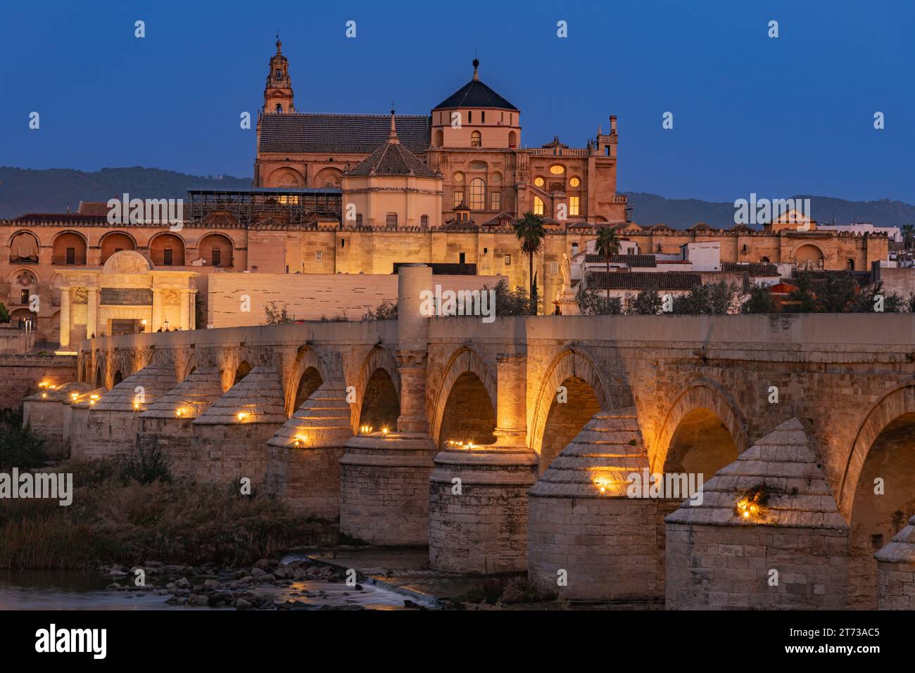 Mosque cathedral of Córdoba and the Roman bridge at dawn and with ...