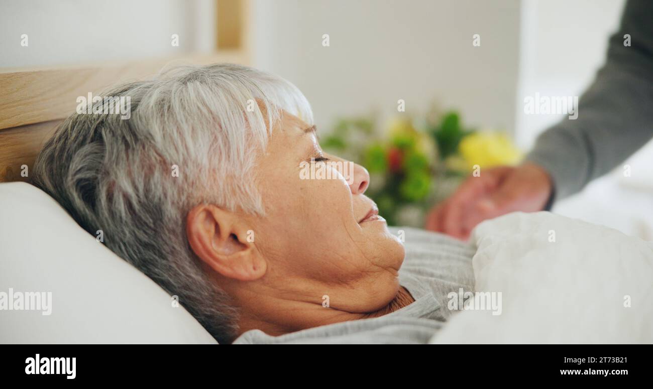 Sleep, tired and a senior woman in bed for peaceful rest or to relax in ...