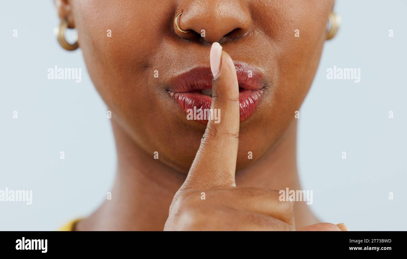 Black woman, mouth and lips in secret for gossip, privacy or confidential information against a ...