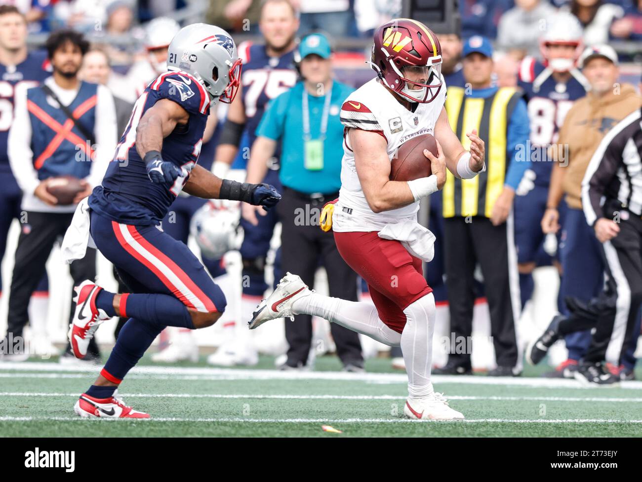 Washington Commanders quarterback Sam Howell (14) with the carry against the New England ...