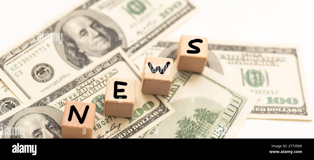 Wooden letters spelling news on money background Stock Photo - Alamy