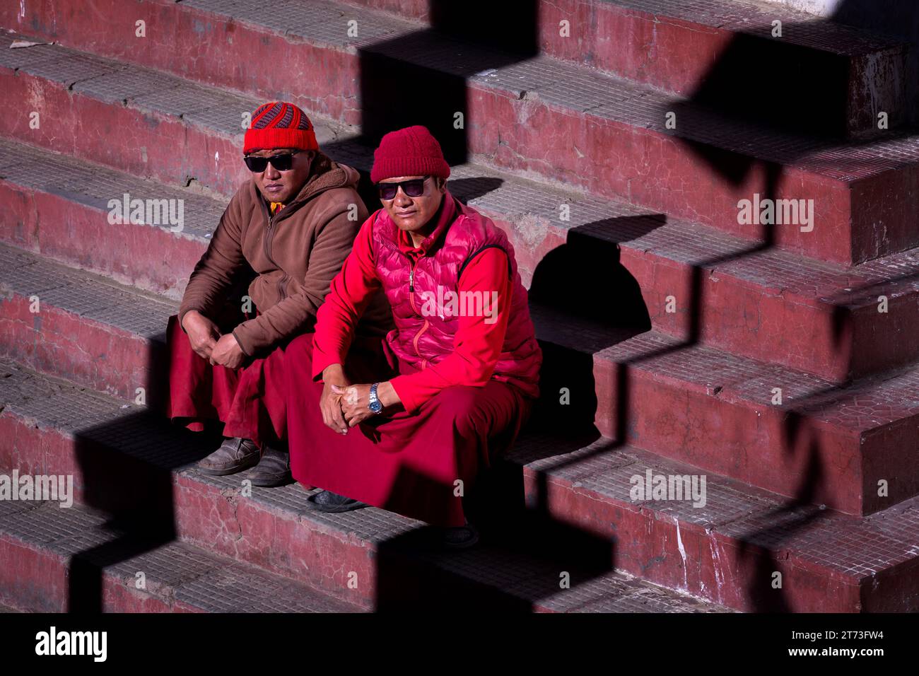 Two monks sitting on the stairs to Korzok monastery, Korzok, Ladakh ...