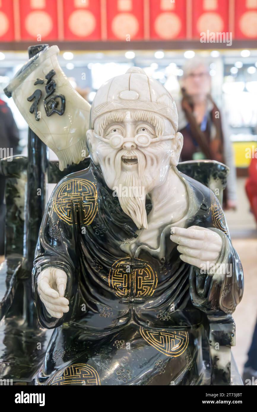 Sculpture of an old jade man dressed in traditional costume Stock Photo ...