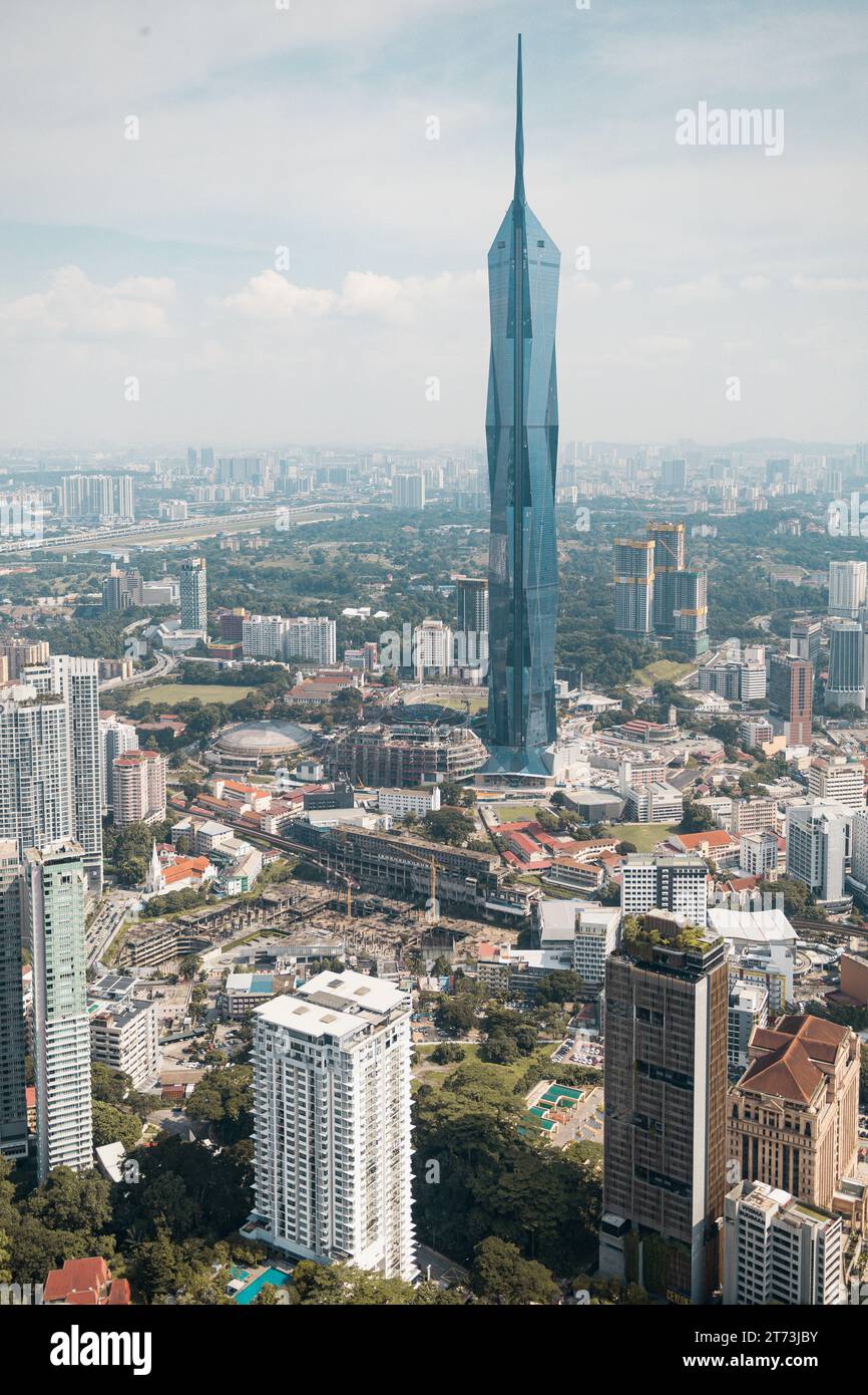An aerial view of a vibrant cityscape featuring a towering skyscraper ...