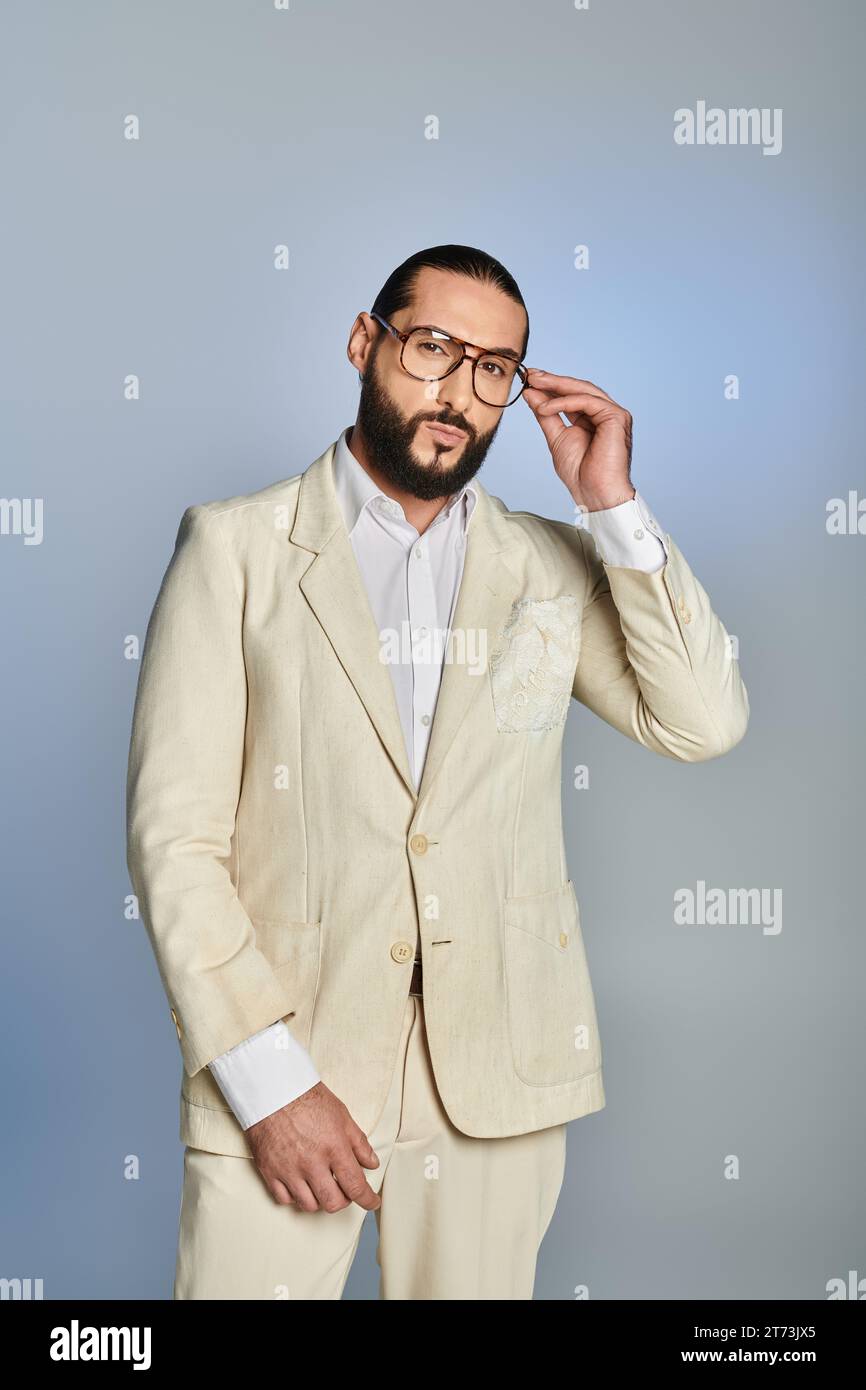 Fashionable And Bearded Man In Eyeglasses And White Attire Posing On