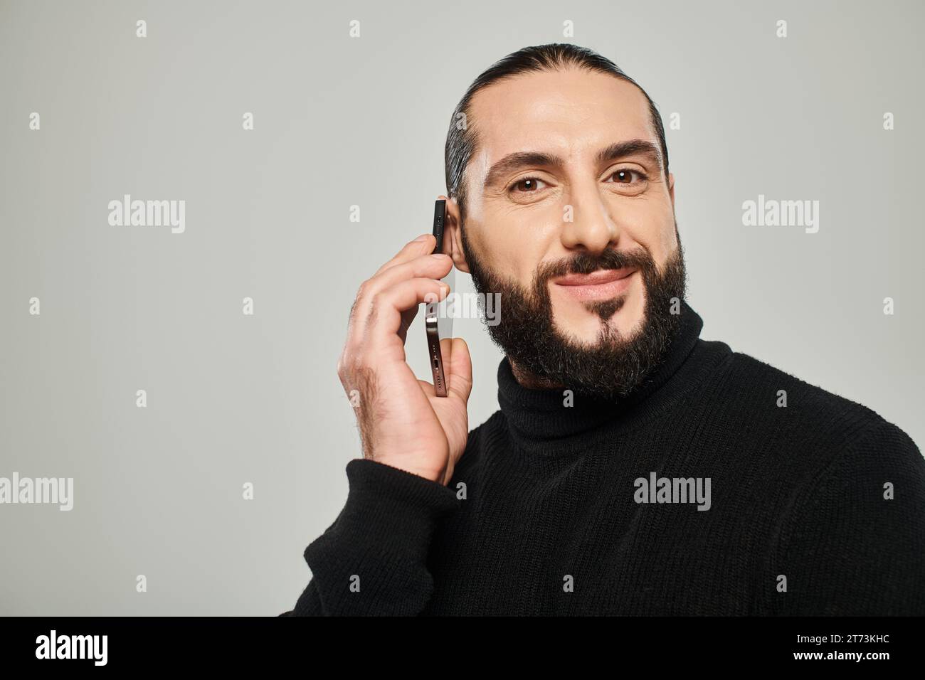happy arabic man with beard smiling and having phone call on smartphone ...