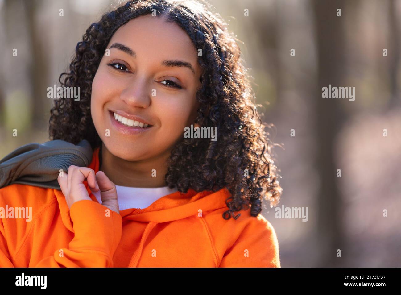 Outdoor portrait of beautiful happy mixed race biracial African ...