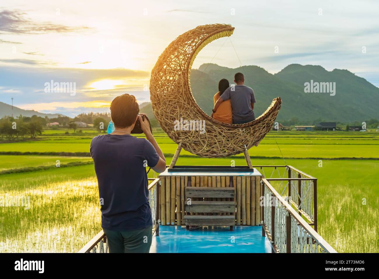 Man using camera to take photo with happiness young couple on crescent ...