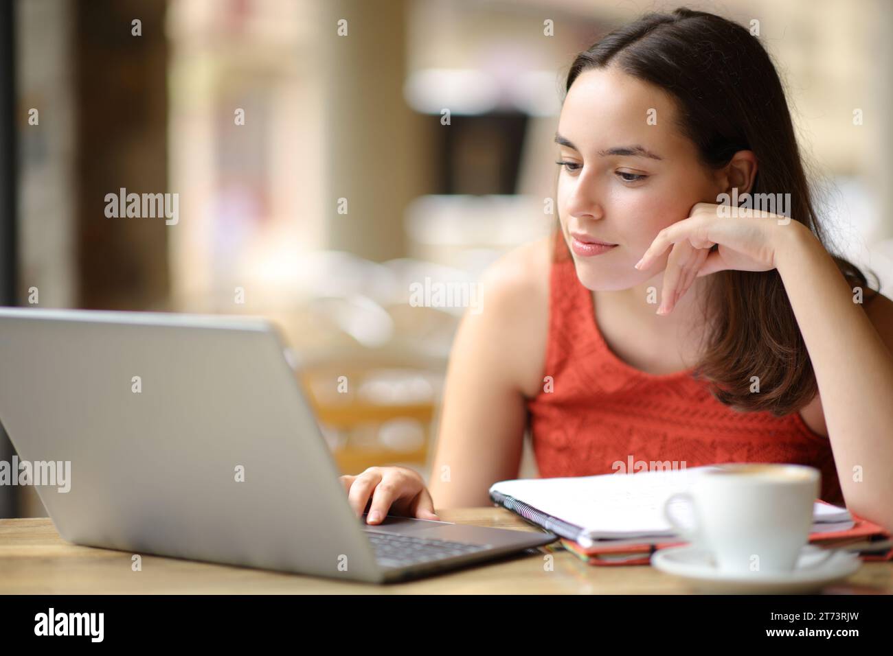Student e-learning with laptop in a coffee shop terrace Stock Photo - Alamy