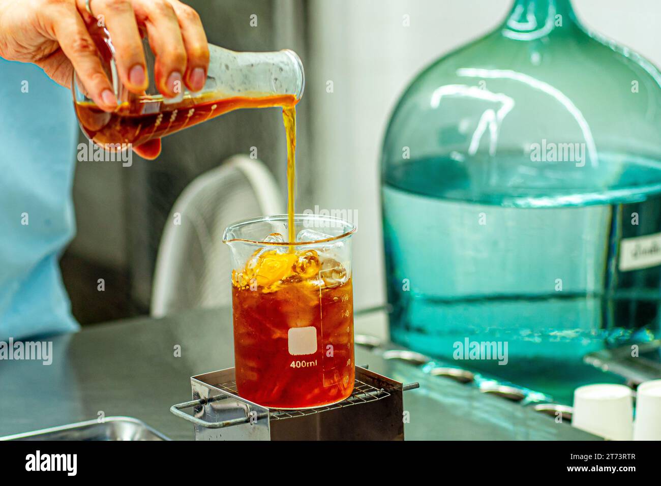 Bartender's Frozen Alchemy: Crafting Ice Beverages in Lab Beaker Glass ...