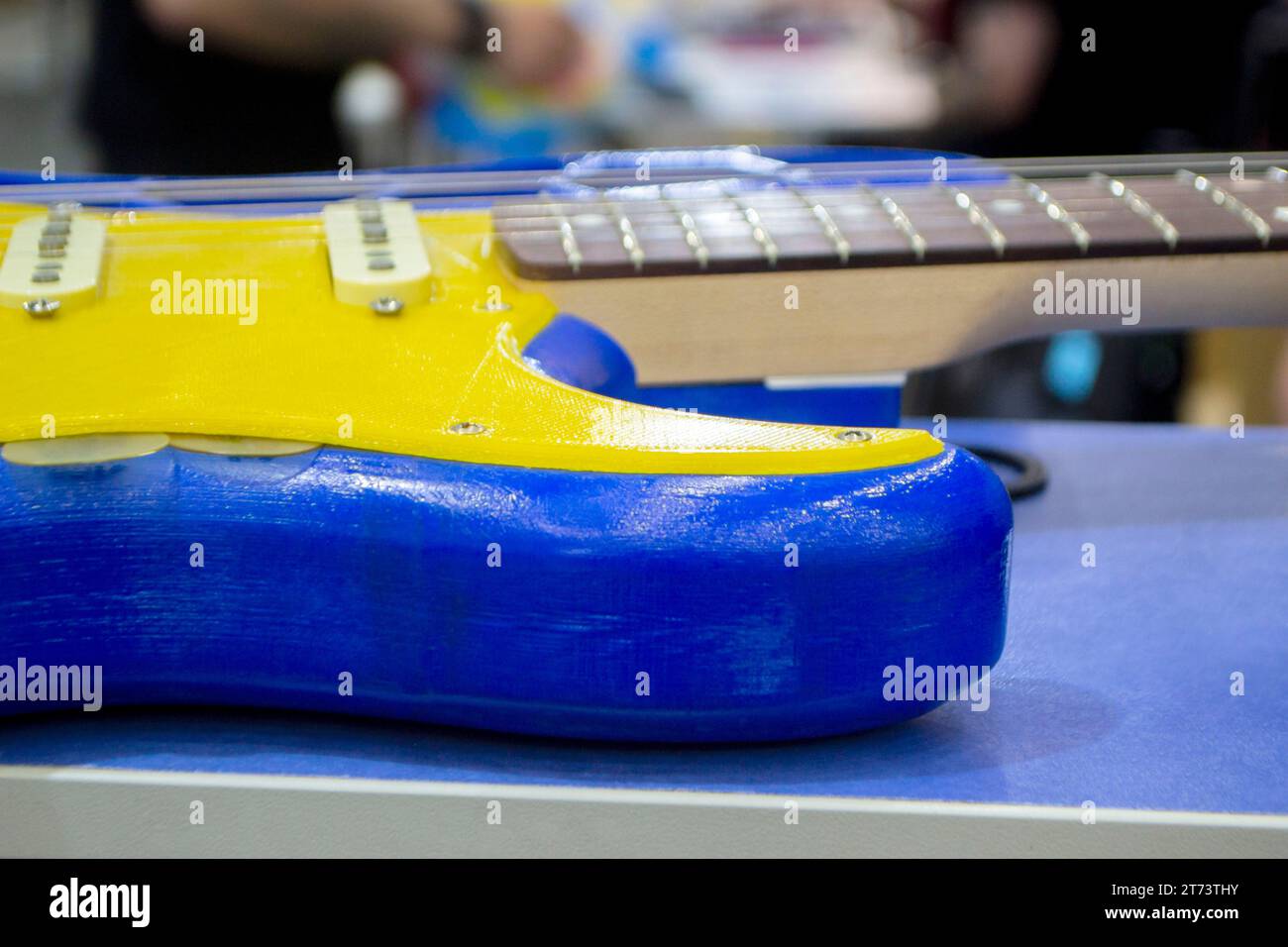 Musical instrument guitar 3D printed from molten plastic in yellow and ...