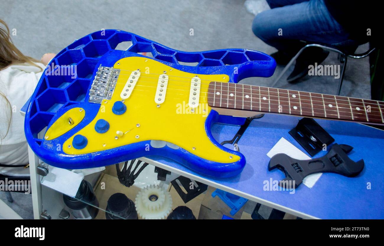 Musical instrument guitar 3D printed from molten plastic in yellow and ...