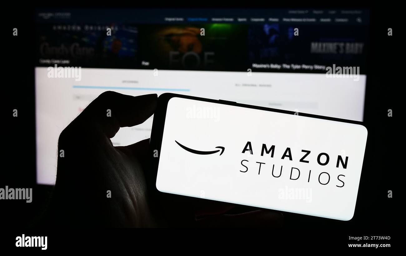 Person holding mobile phone with logo of US film and television ...