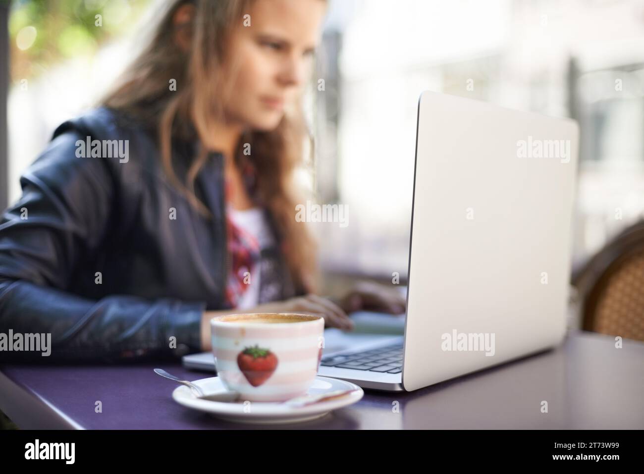 College student, working and laptop outdoor at coffee shop, cafe or ...