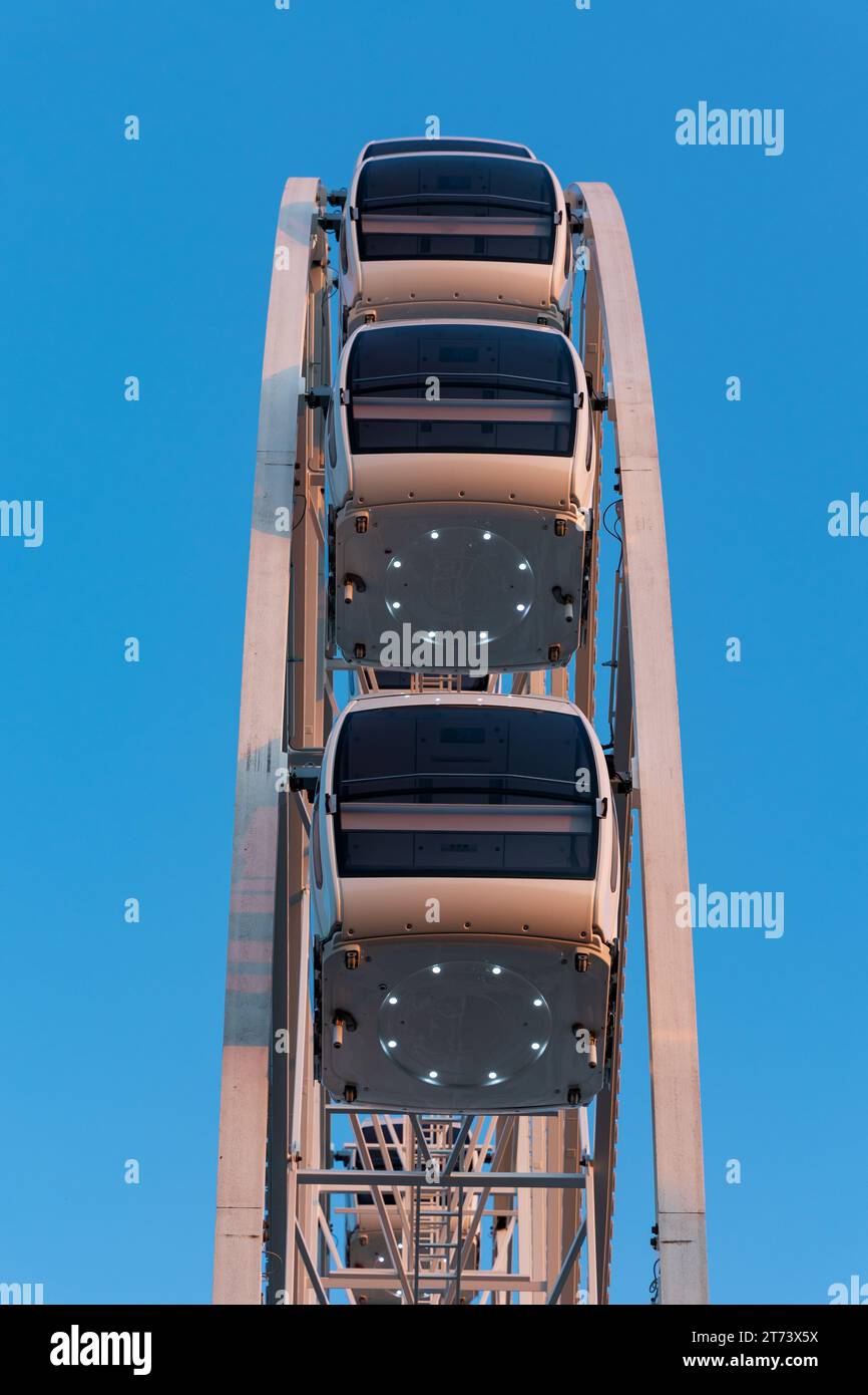 Ferris wheel in the background of the blue sky. Details of steel ...