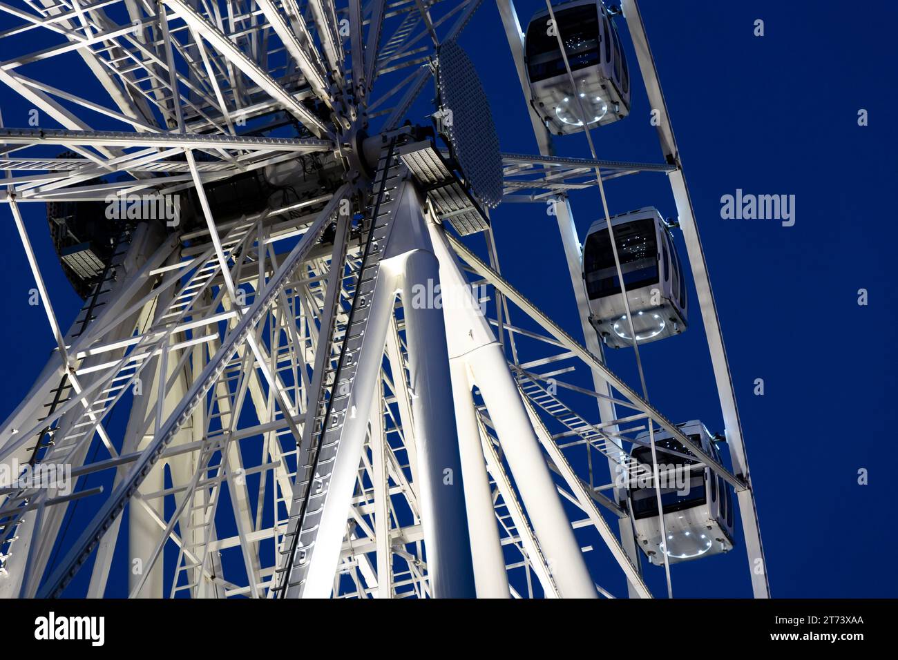 Ferris wheel in the background of the early evening sky. Details of ...