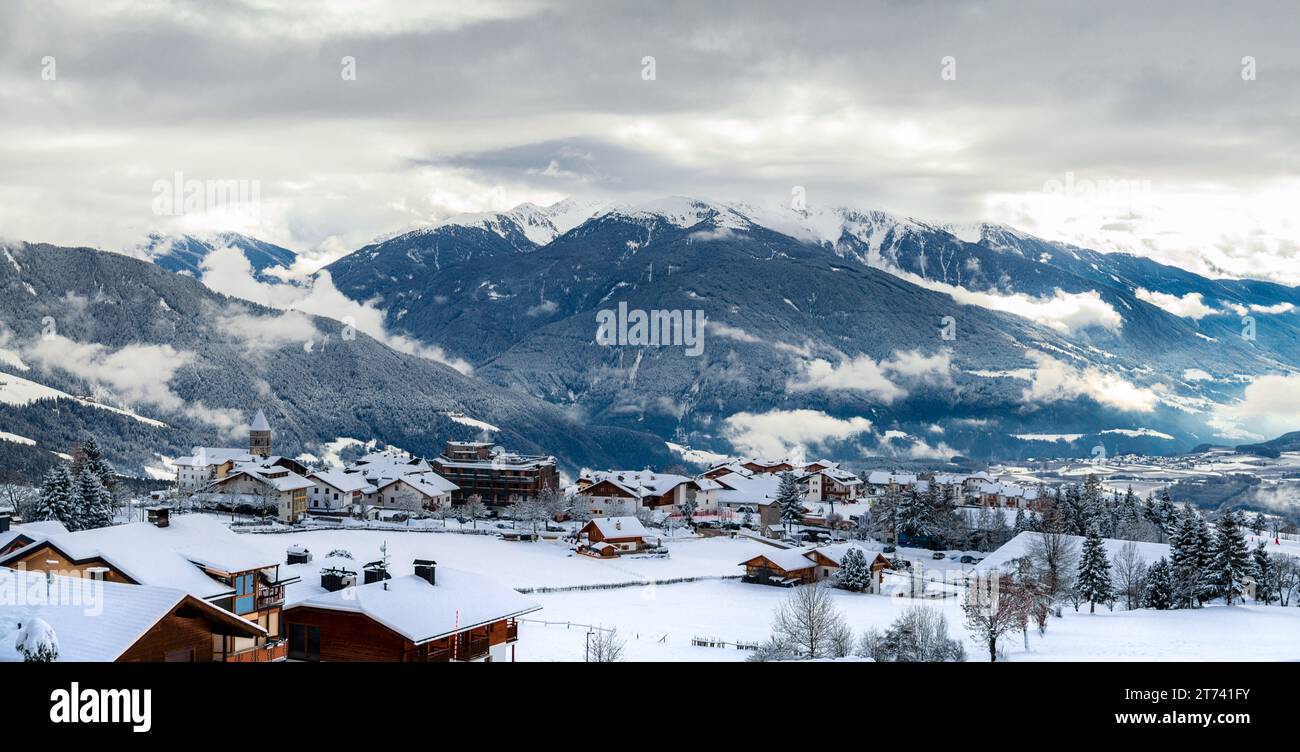 snowy village in the alps cloudy mountains in the background, panoramic ...