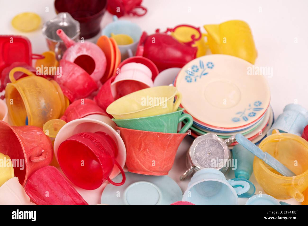 A collection of small plastic toy dishes in many colors, close up ...