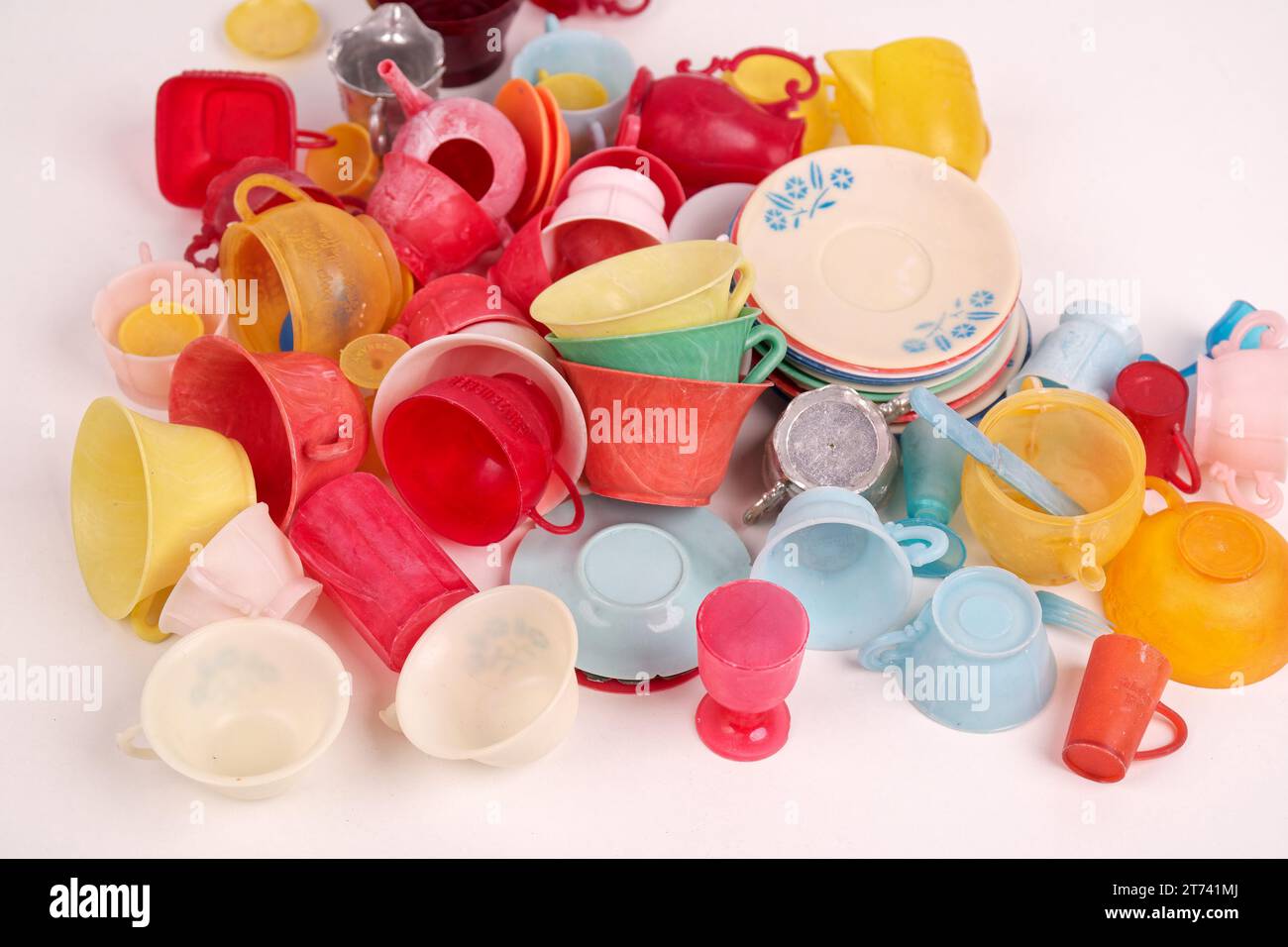 A collection of small plastic toy dishes in many colors, close up ...