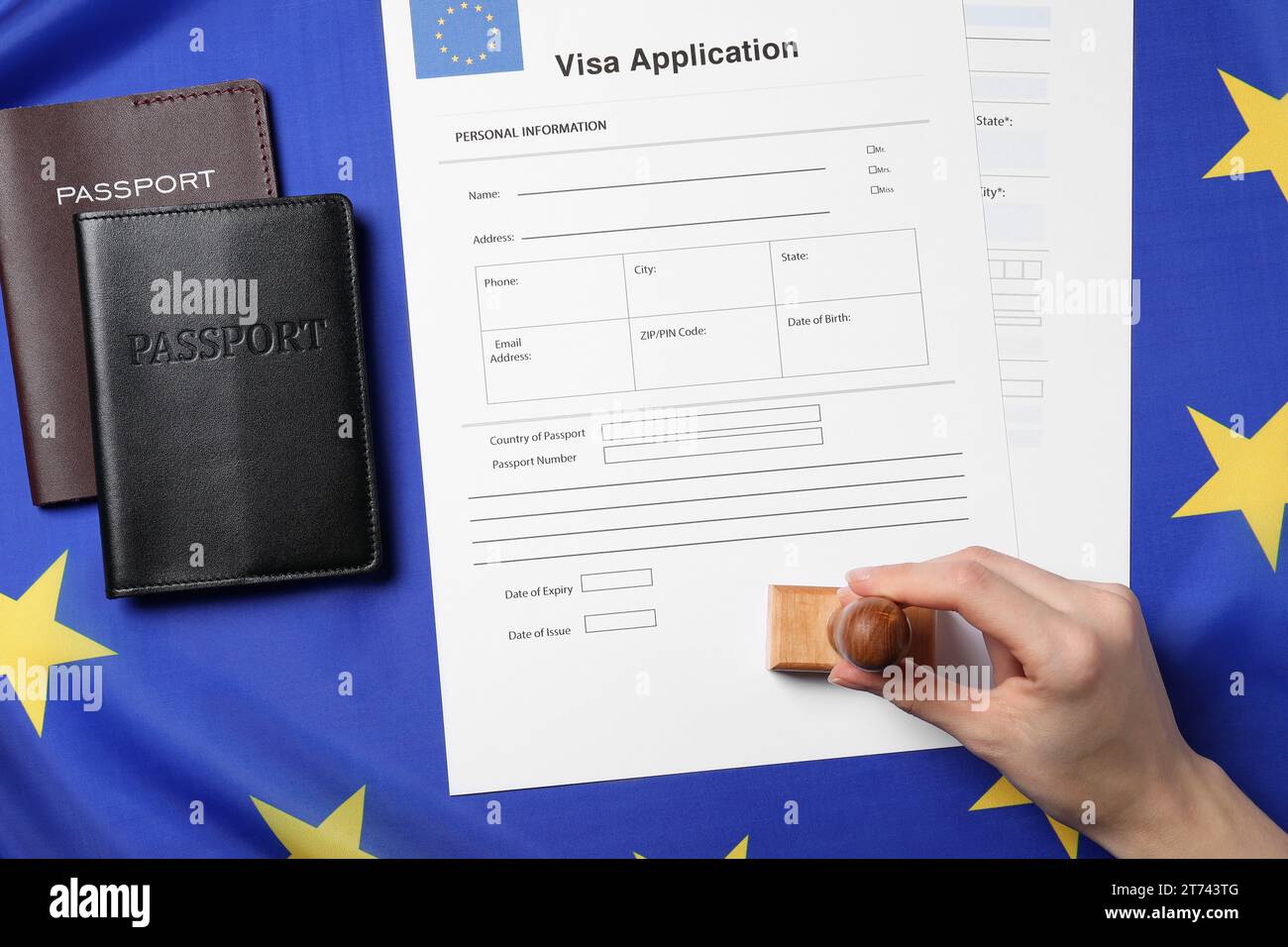 Immigration to European Union. Woman stamping visa application forms on ...