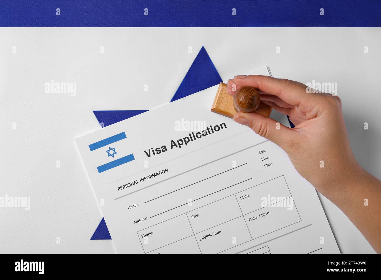 Immigration to Israel. Woman stamping visa application form on flag ...