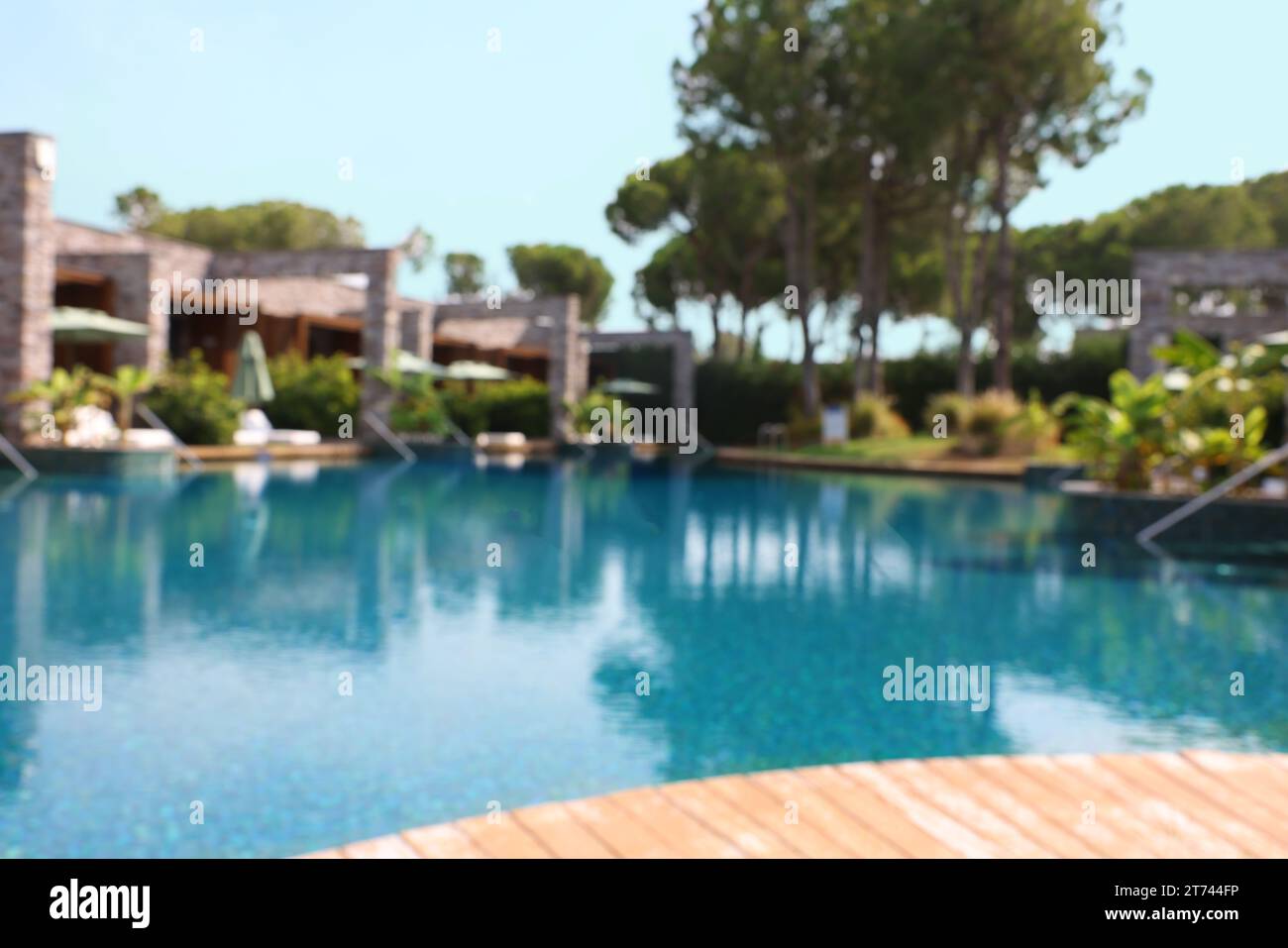Outdoor swimming pool at resort, blurred view Stock Photo - Alamy