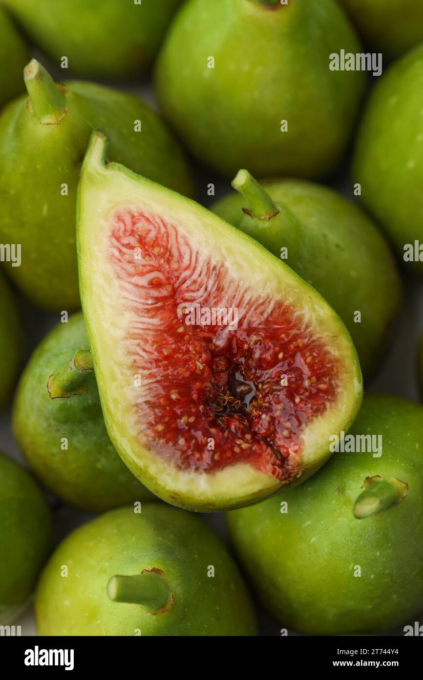 Cut and whole fresh green figs as background, top view Stock Photo - Alamy