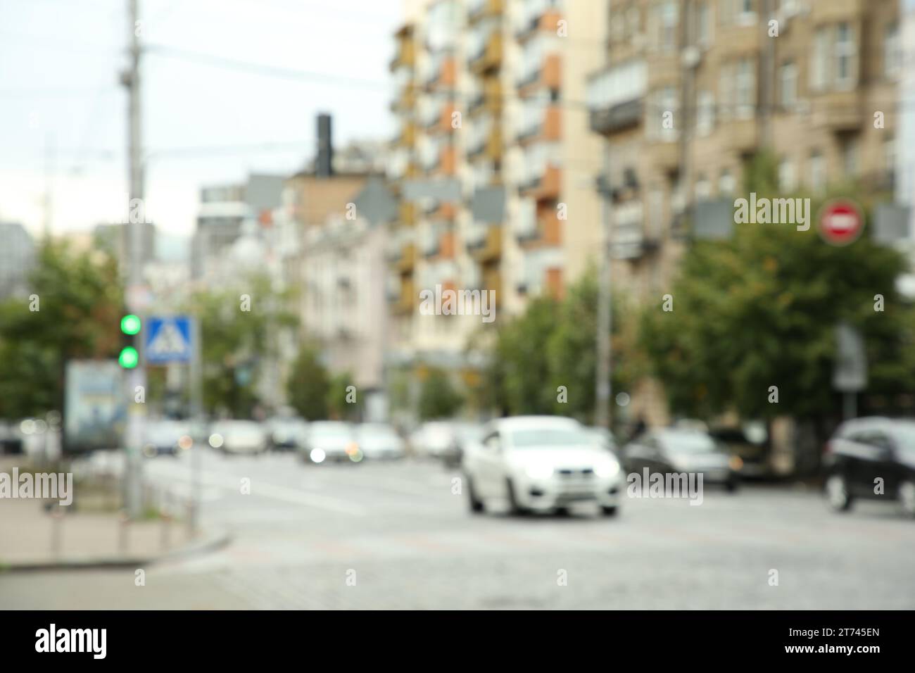 Blurred view of quiet city with buildings and cars on road Stock Photo ...
