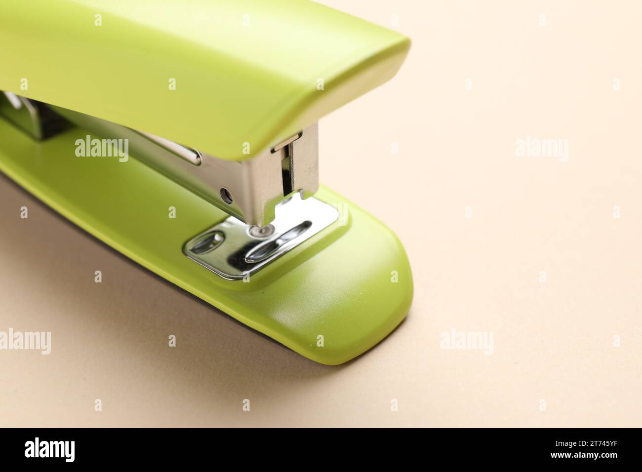 One bright stapler on beige background, closeup. Space for text Stock ...