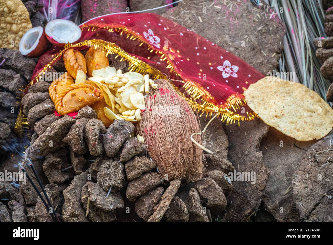 cow dung cakes with coconut, flat bread roti and red cloth essential ...