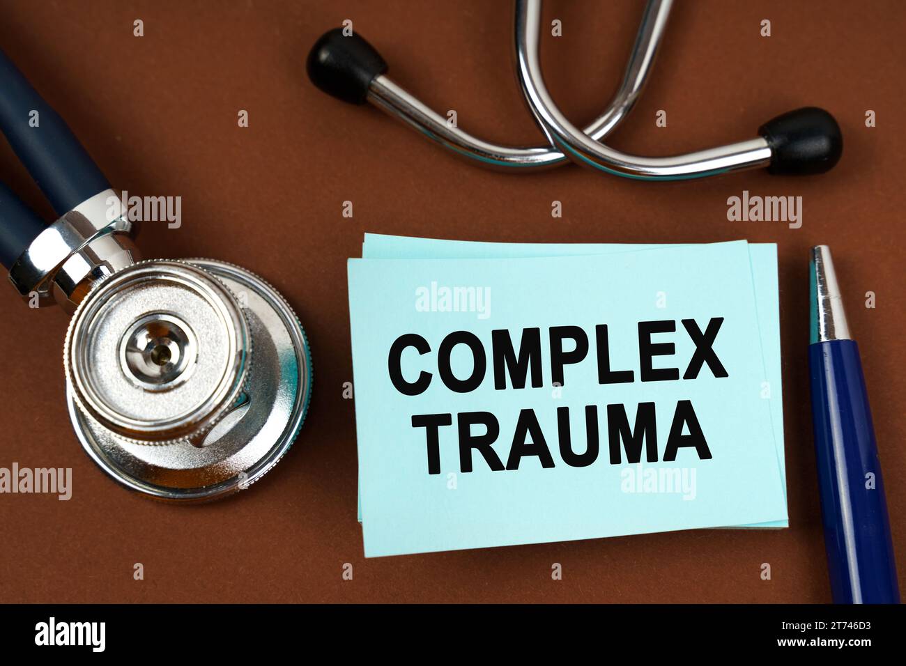 Medical concept. On a brown surface there is a stethoscope, a pen and ...