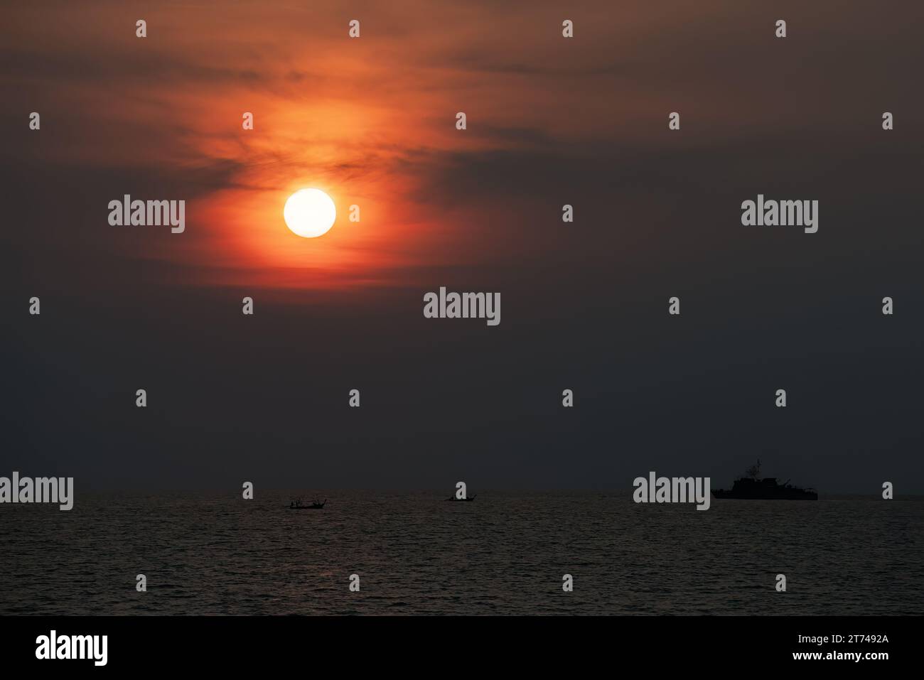 Scenic golden red sunset, Sun partly behind clouds, Tropical sky ...
