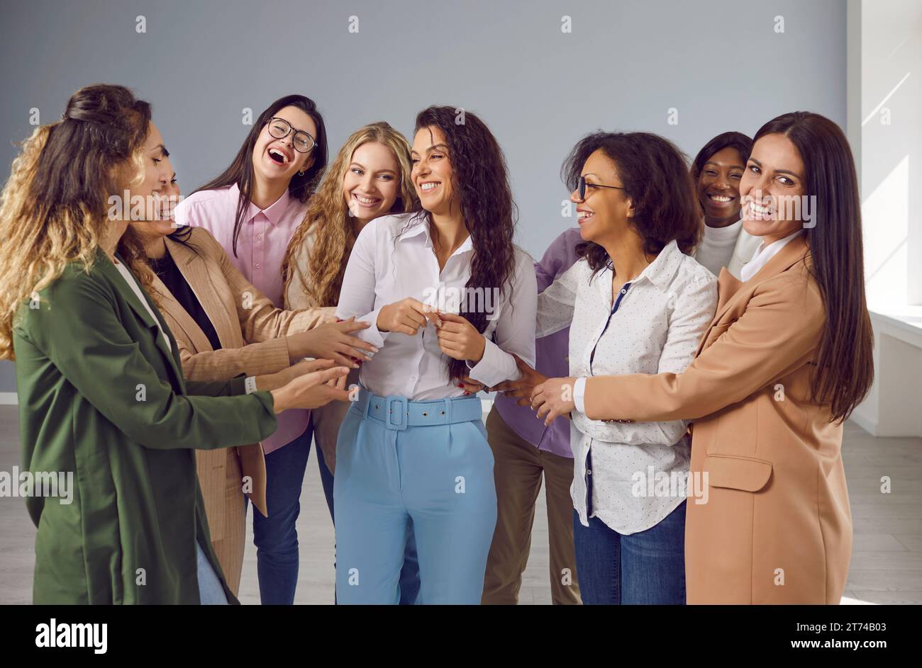 Team of happy young diverse business women congratulating their friend ...