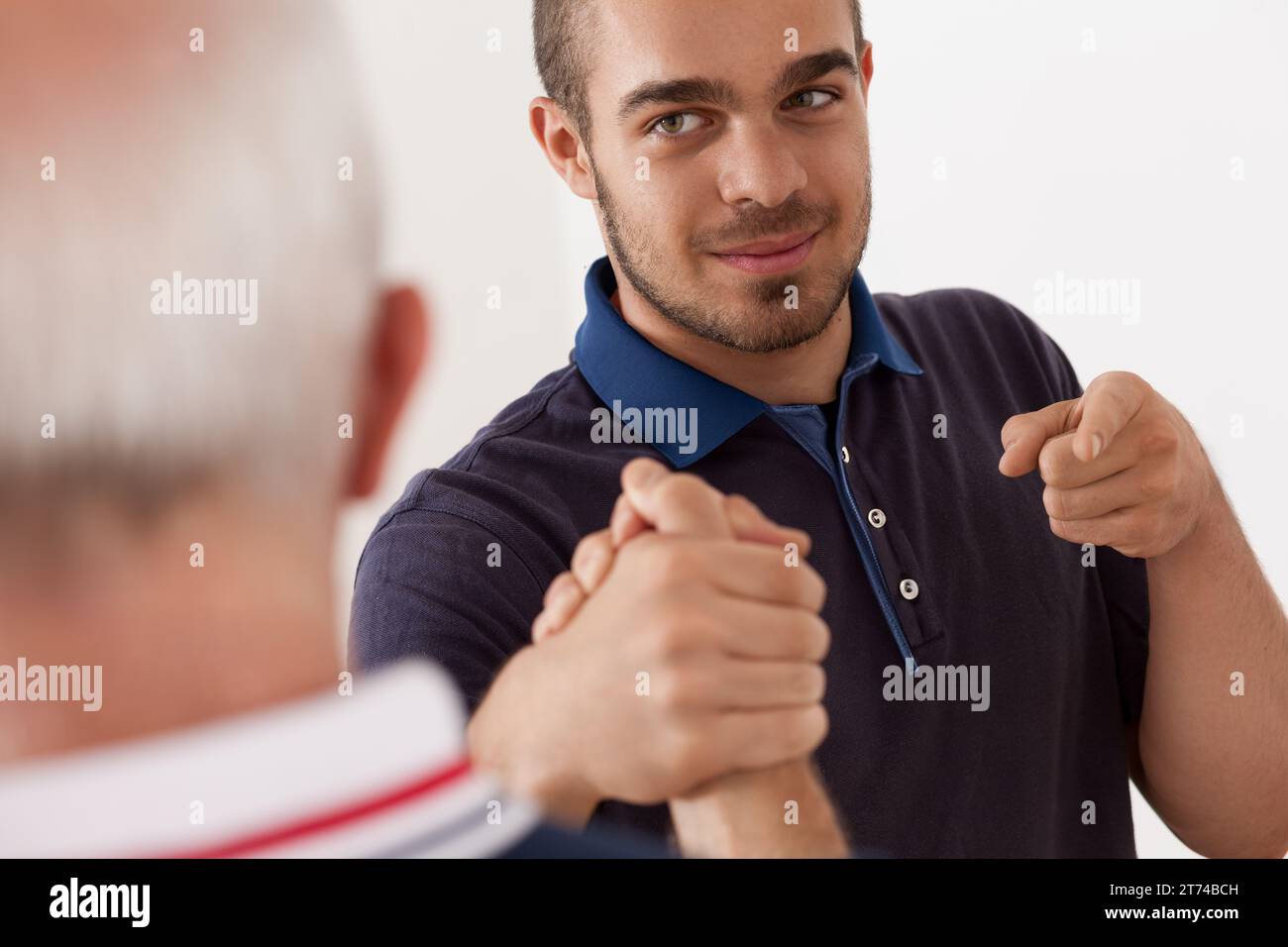Young man's gesture points to his older colleague, signifying trust and ...