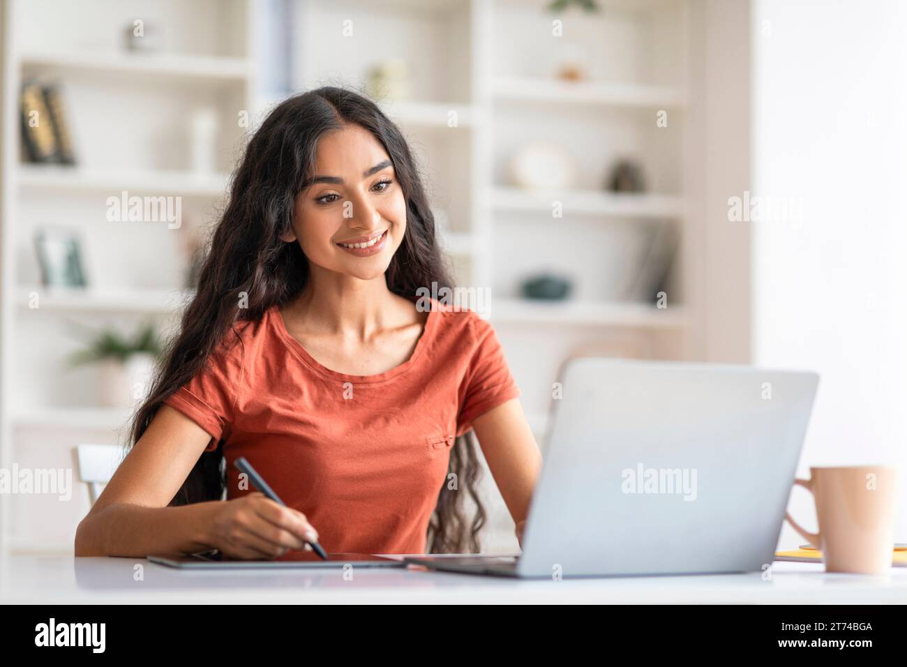 Positive young woman absorbed in hi-res stock photography and images ...