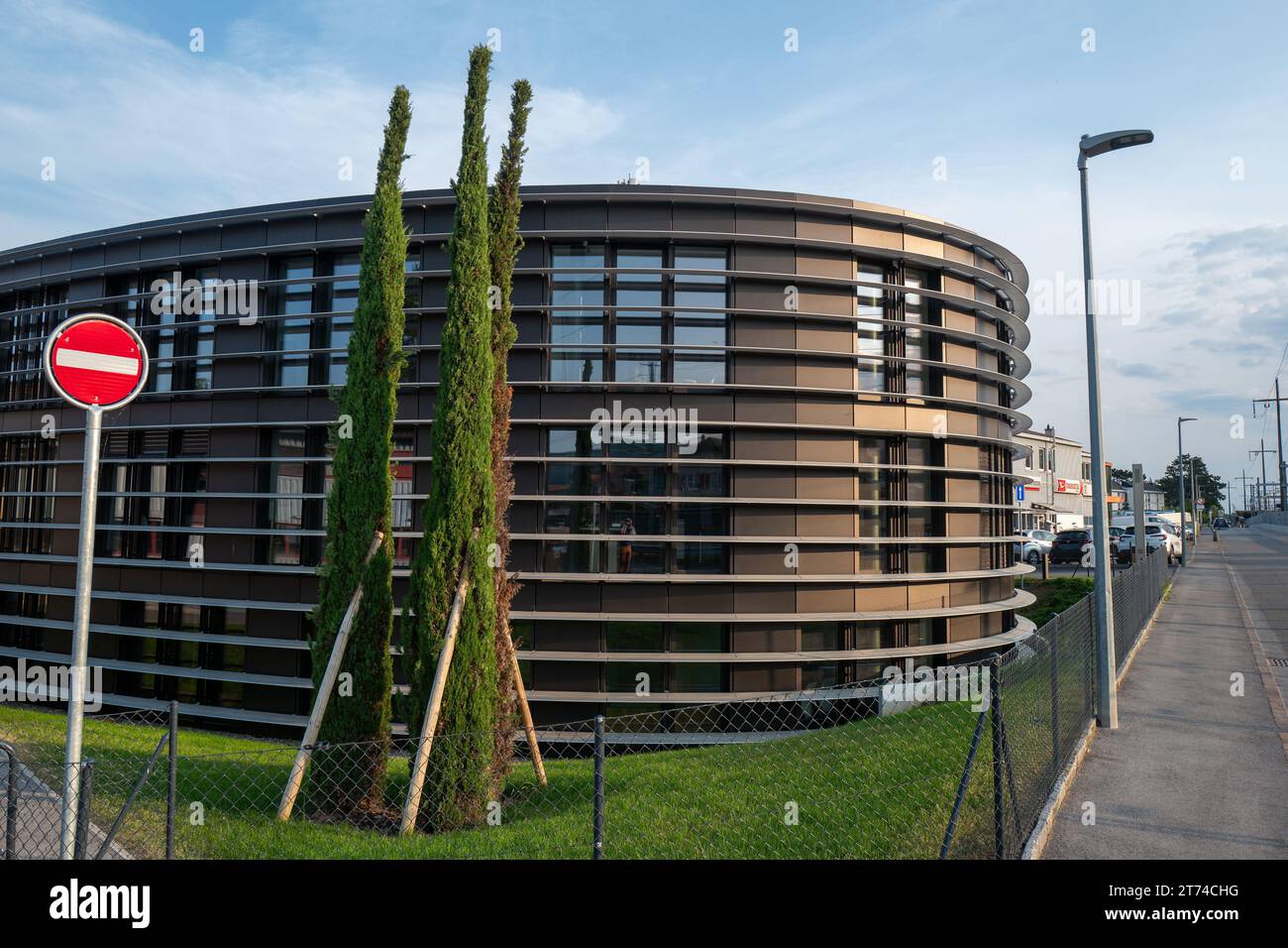 An aerial view of a large oval-shaped building with a stop sign at its ...