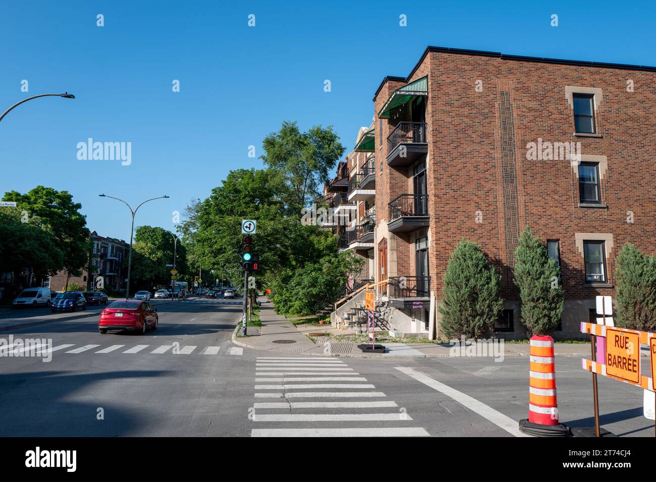 Two signs placed on the side of a busy city street, surrounded by ...