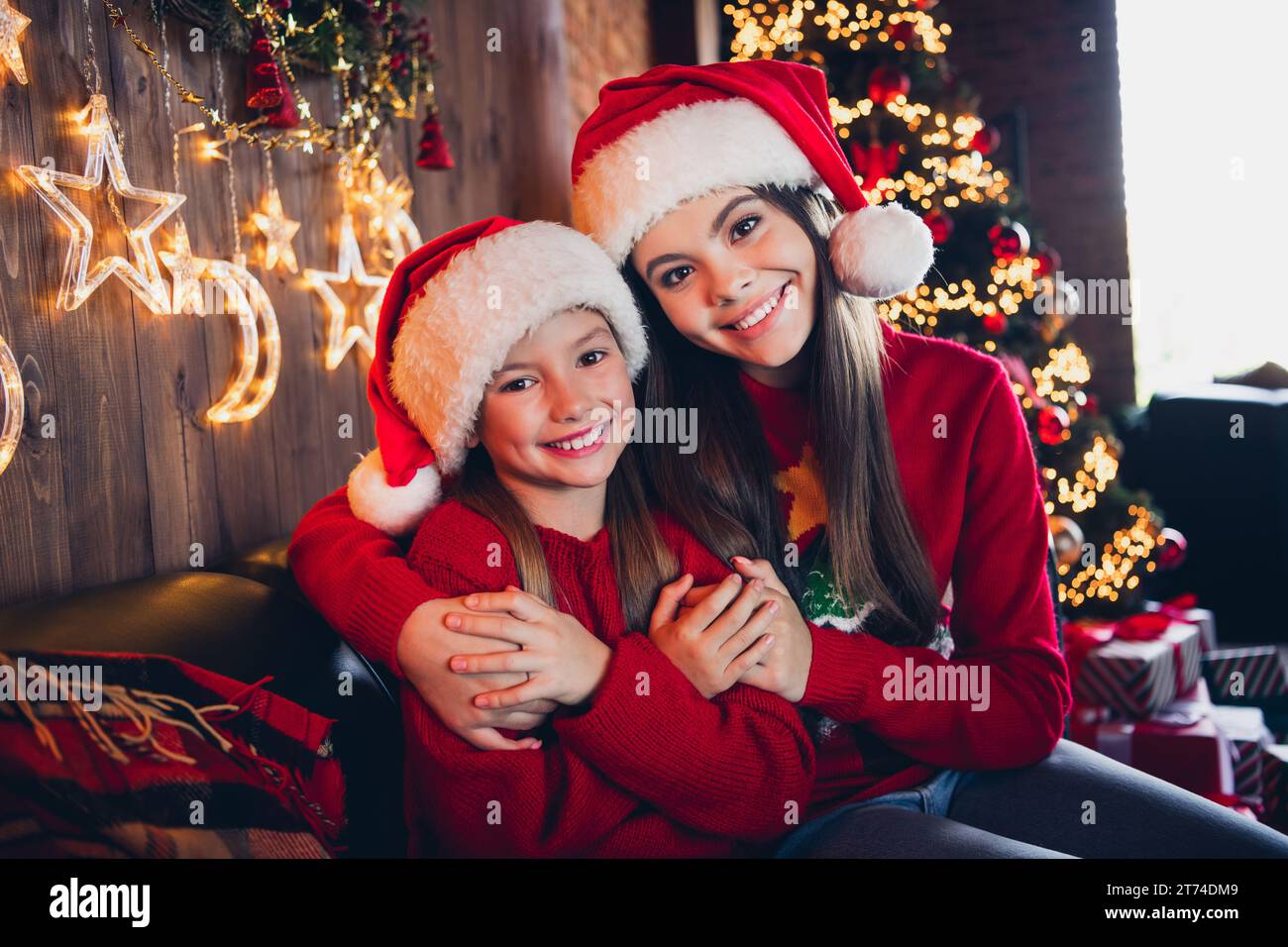 Photo of pretty charming small sisters wear red ugly print new year ...