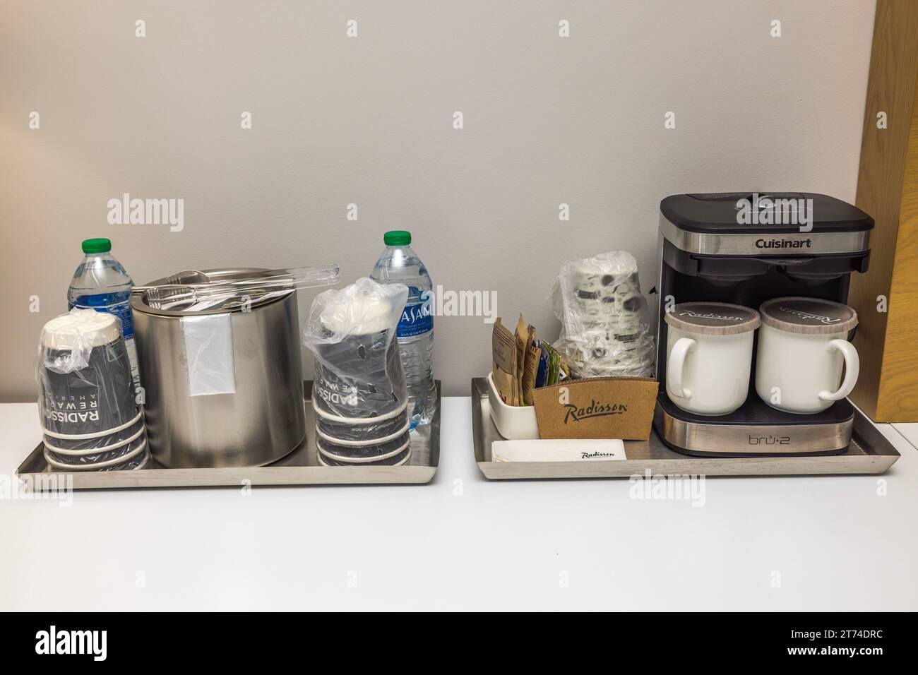 Hotel room table set with guest amenities, including coffee machine and ...