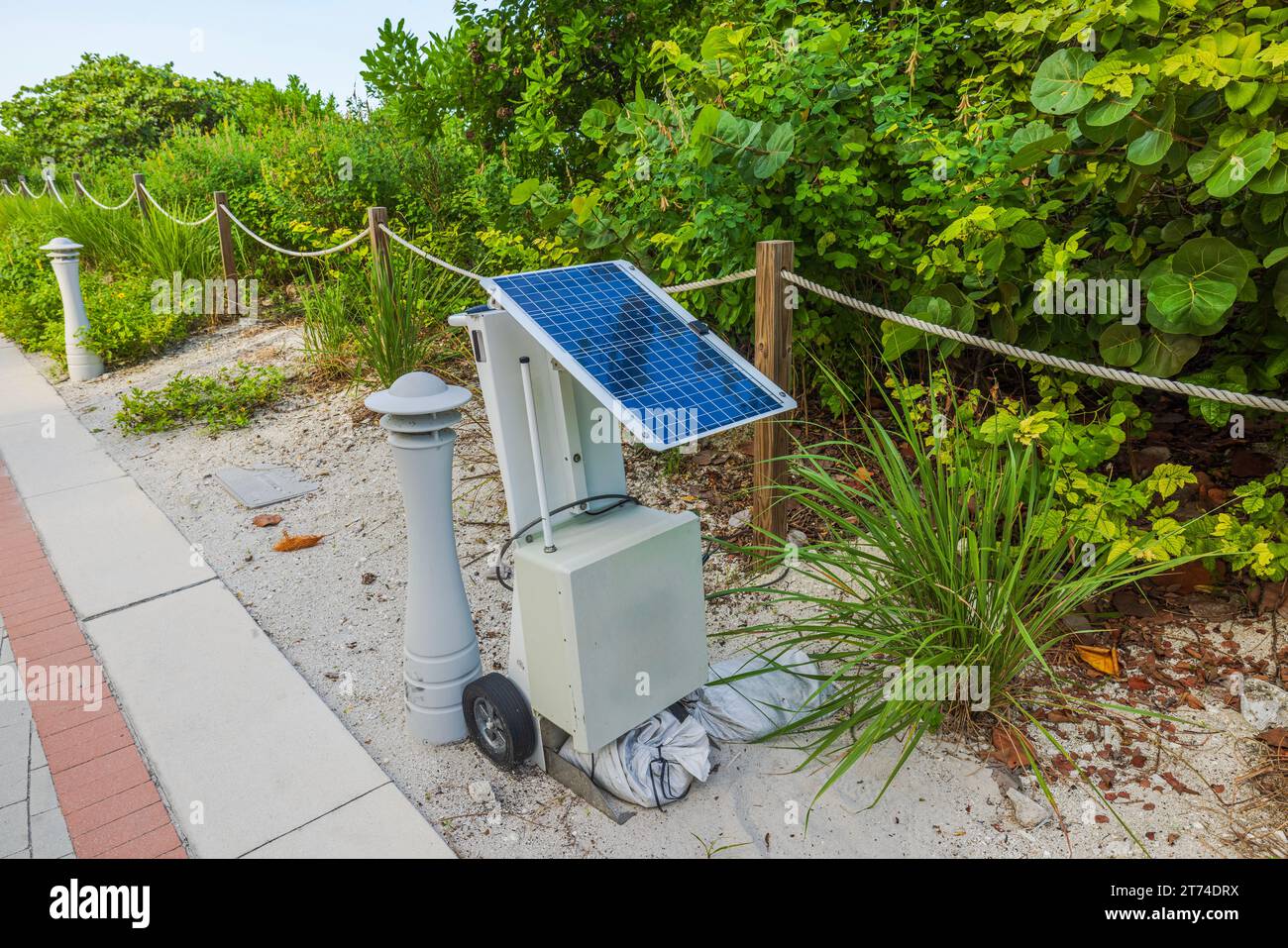 Close-up view of portable solar power station situated along red trail ...
