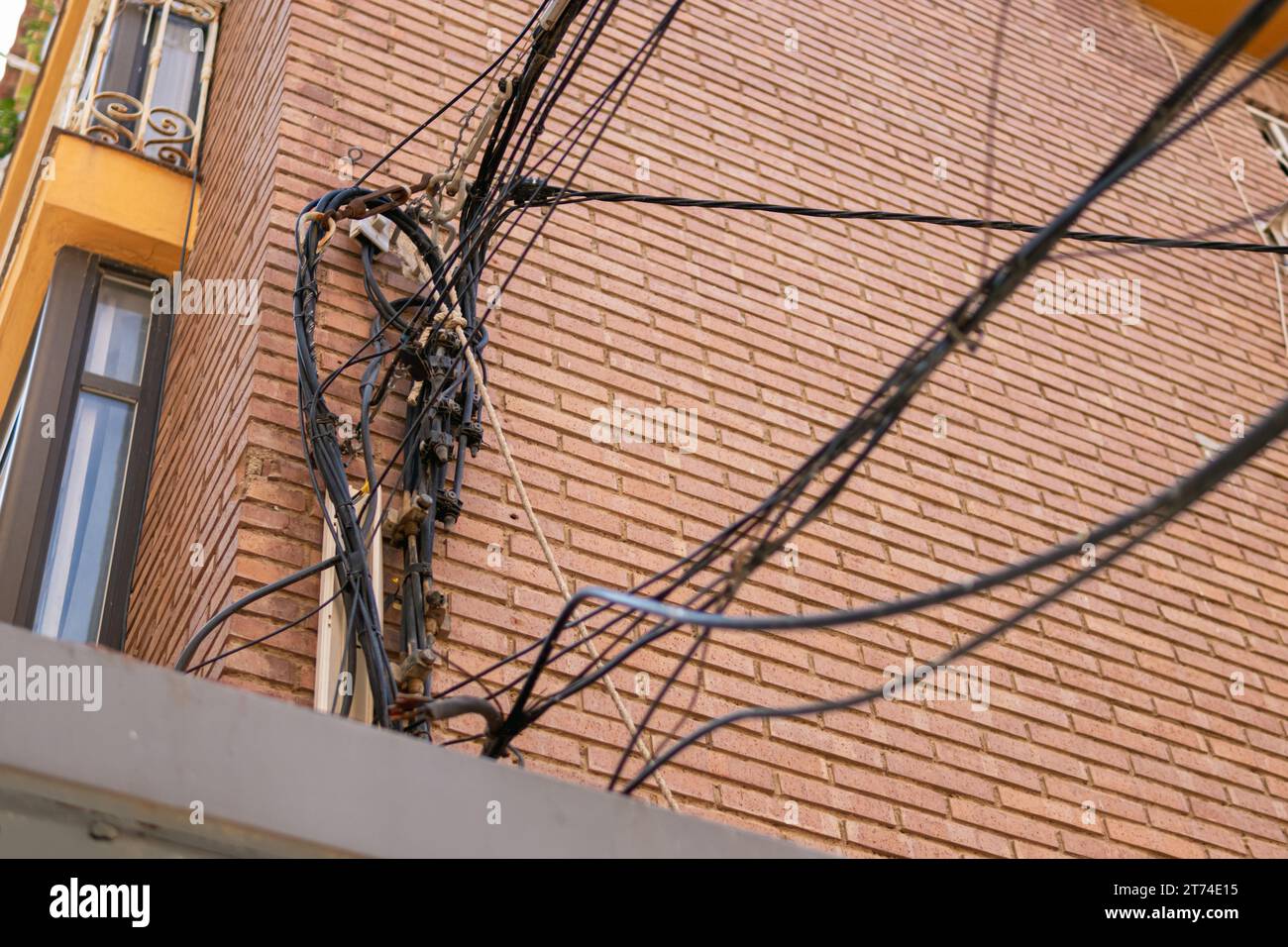 many electrical wires on the wall of a multi-story building Stock Photo ...