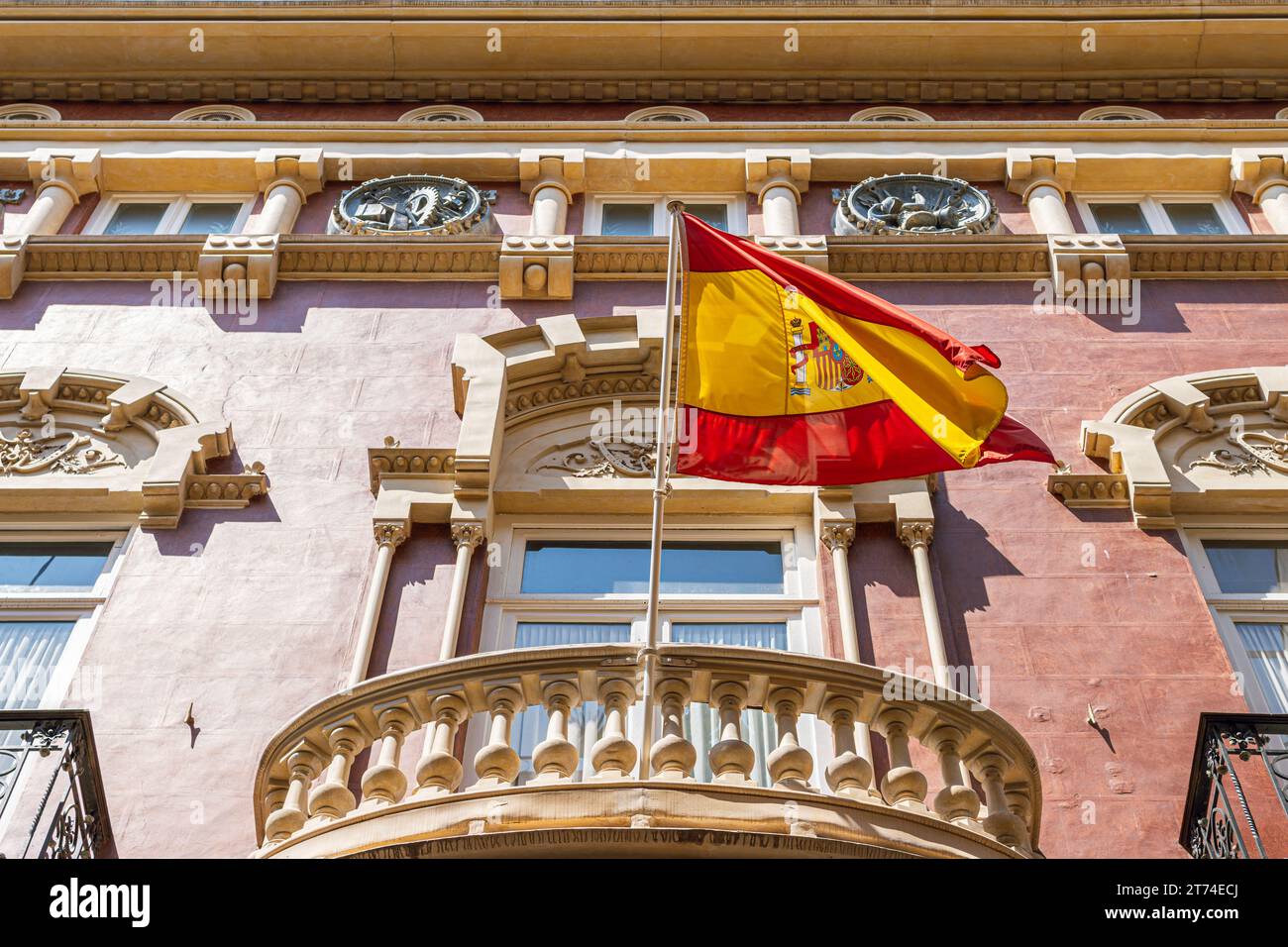 Low angle shot spain flag waving at top of building Stock Photo - Alamy