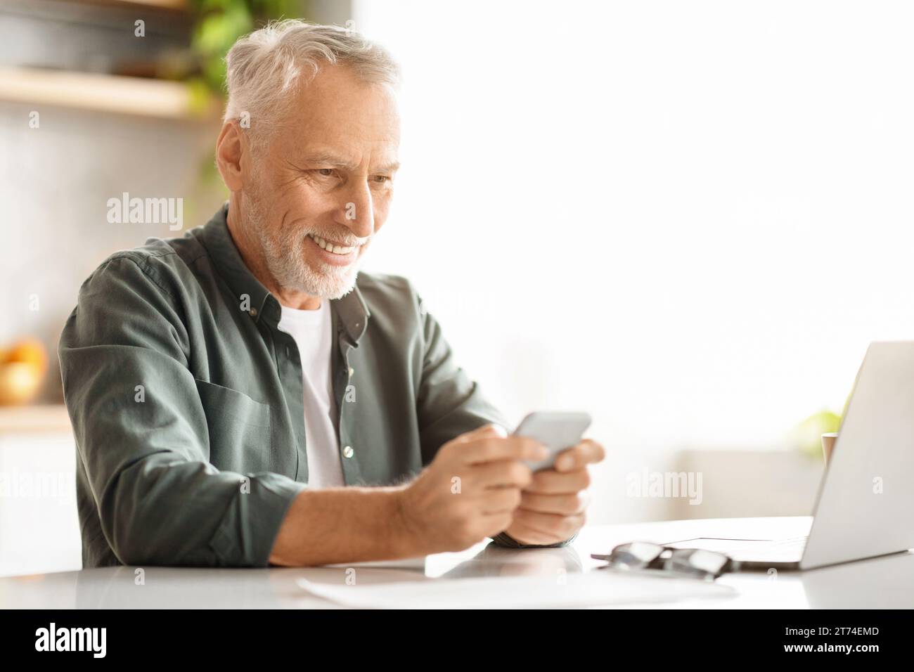 Happy older man using phone hi-res stock photography and images - Alamy