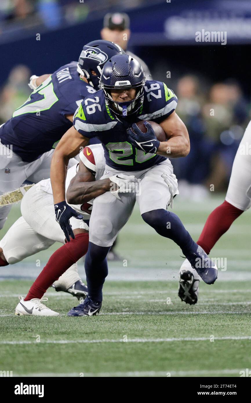 Seattle Seahawks running back Zach Charbonnet is hit from behind by ...
