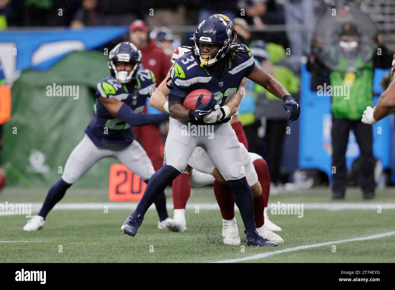 Seattle Seahawks running back DeeJay Dallas is hit from behind on a put ...