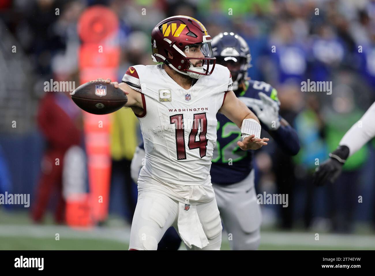 Washington Commanders quarterback Sam Howell passes under pressure from ...