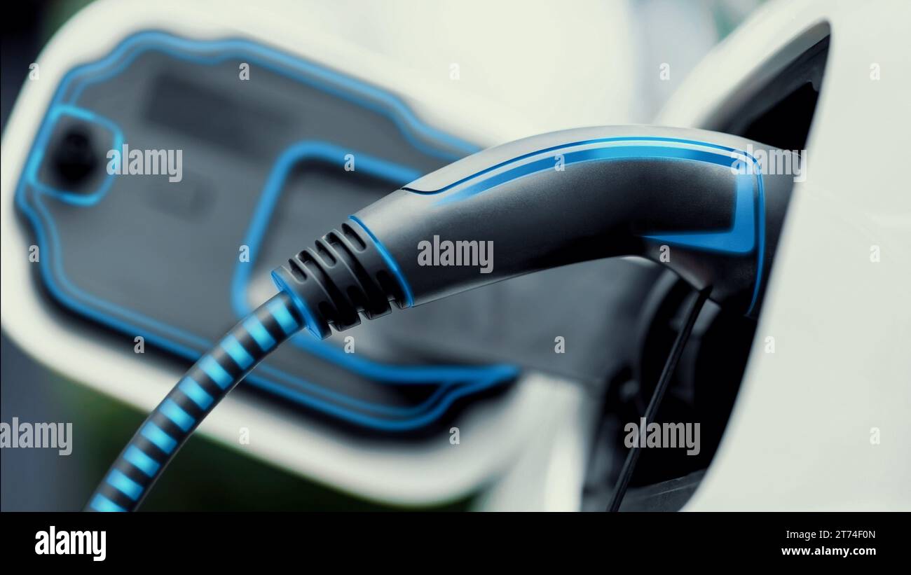 Closeup EV charger plugged into electric car for electric recharging ...