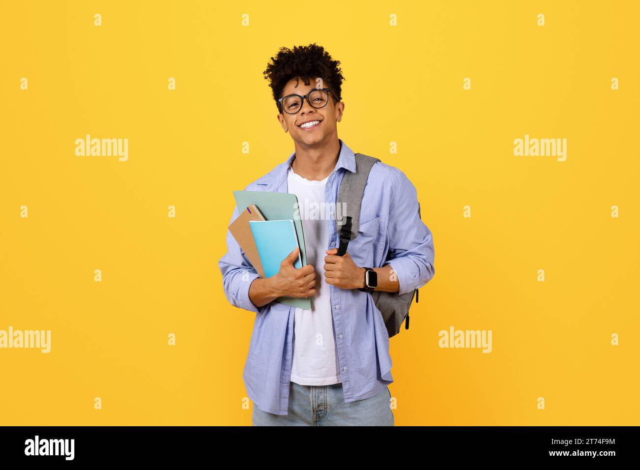 Happy black student guy with books and backpack Stock Photo - Alamy